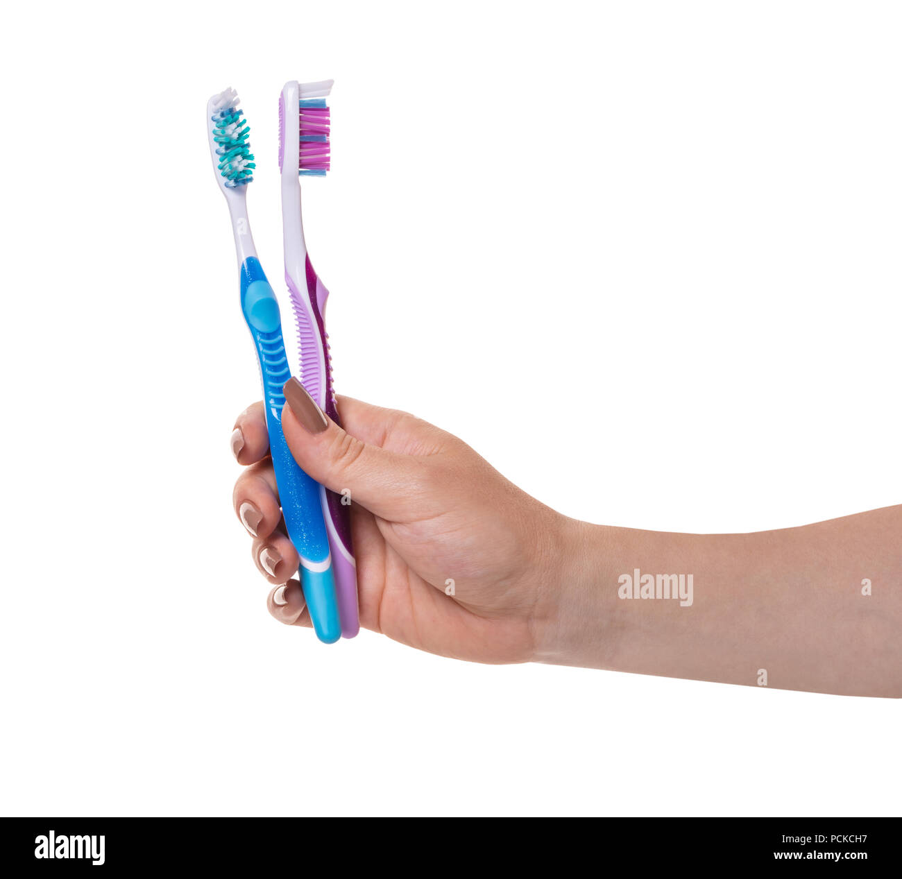 toothbrushes in a female hand on white isolated background Stock Photo ...