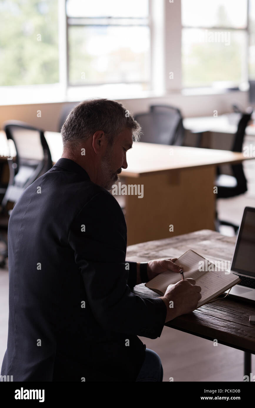 Man writing on desk in hi-res stock photography and images - Alamy