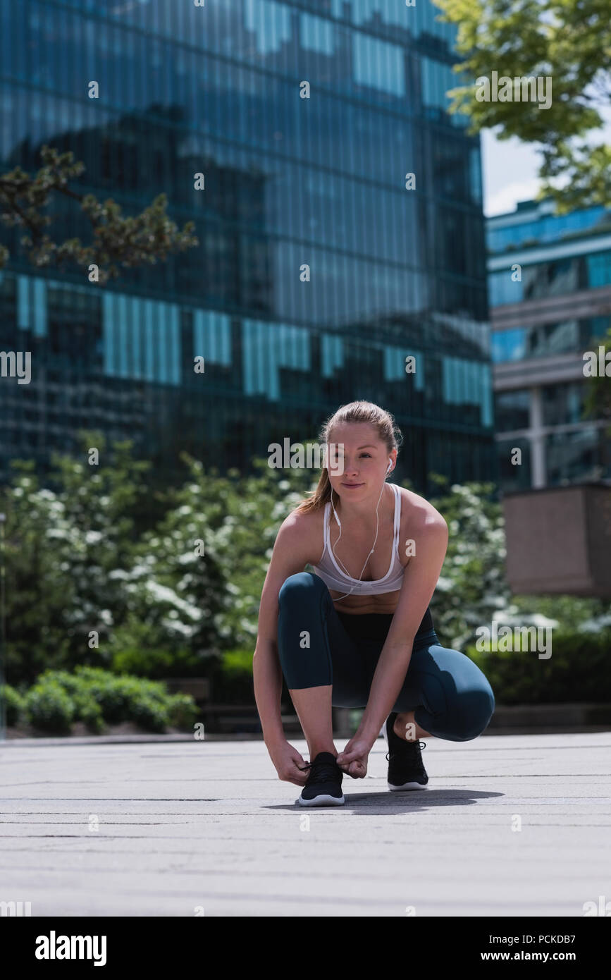 Woman tying shoe laces hi-res stock photography and images - Alamy