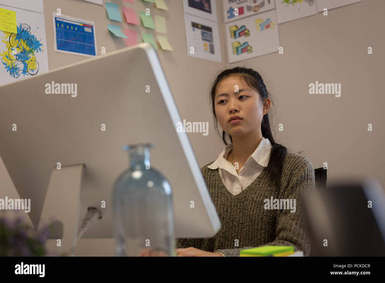 Asian female entrepreneur working on hi-res stock photography and ...