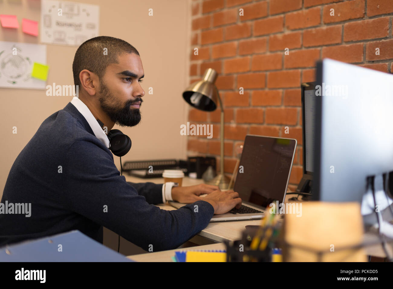 Attentive male executive using laptop hi-res stock photography and ...