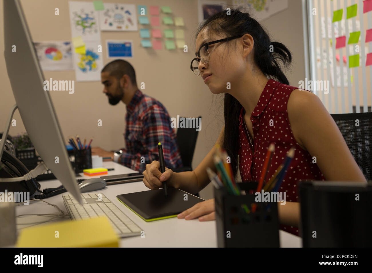 Female graphic designer using graphics hi-res stock photography and ...