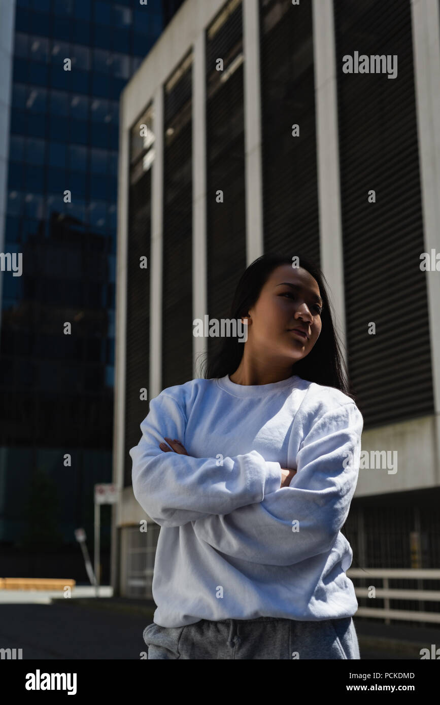 Female dancer standing with arms crossed Stock Photo - Alamy