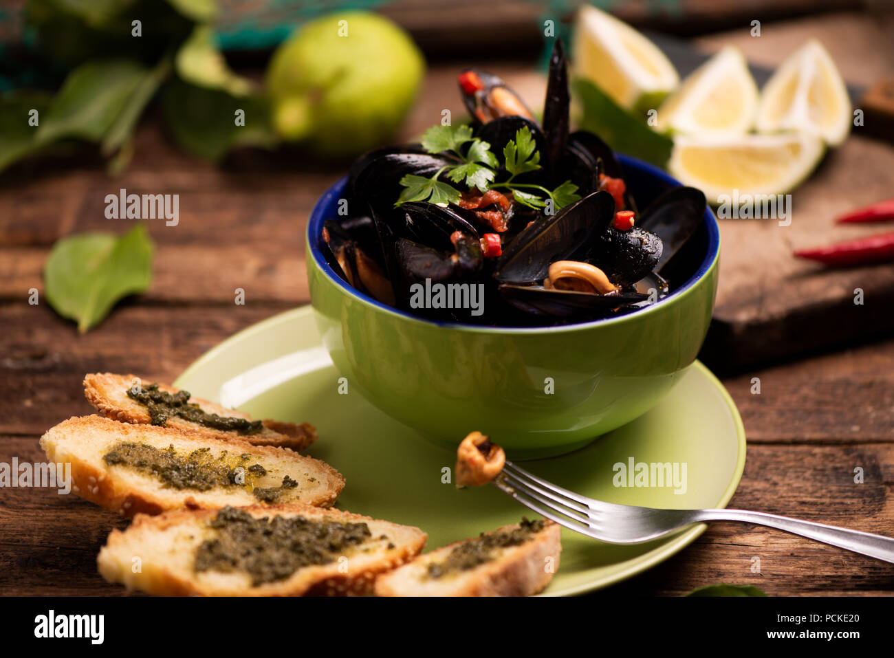 Boiled mussels in cooking dish on wooden background Stock Photo - Alamy