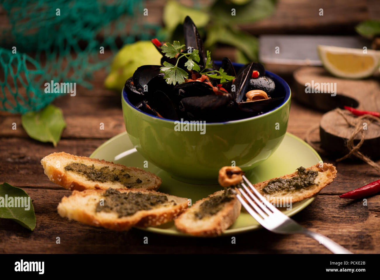 Boiled mussels in cooking dish on wooden background Stock Photo - Alamy