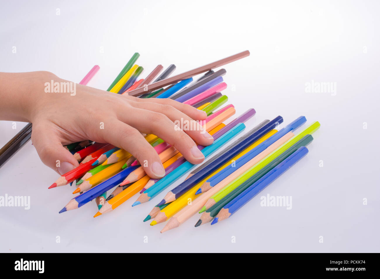 Hand holding Color pencils on a white background Stock Photo - Alamy