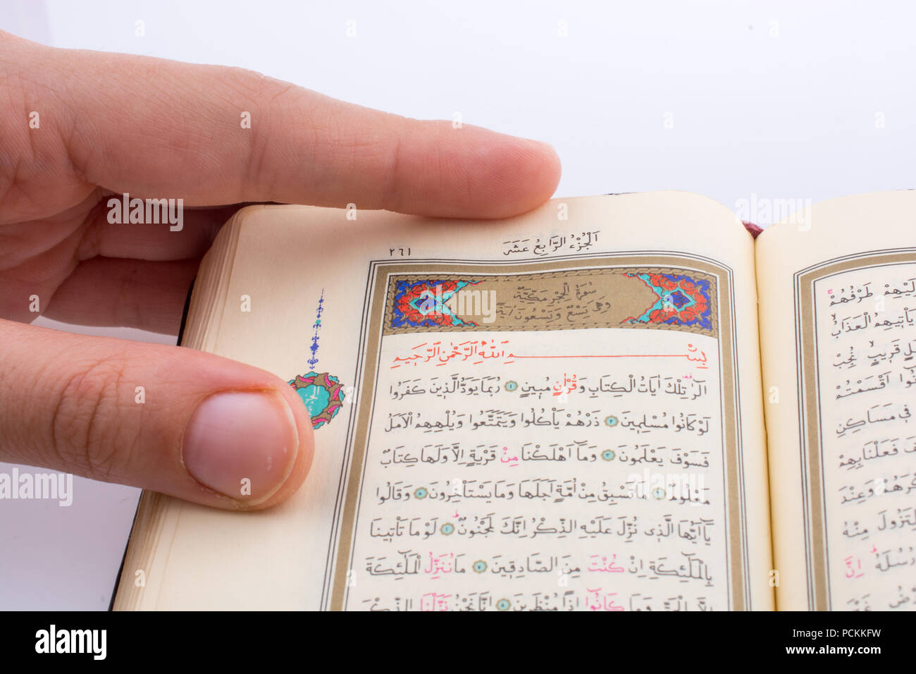 Hand holding The Holy Quran on a white background Stock Photo - Alamy
