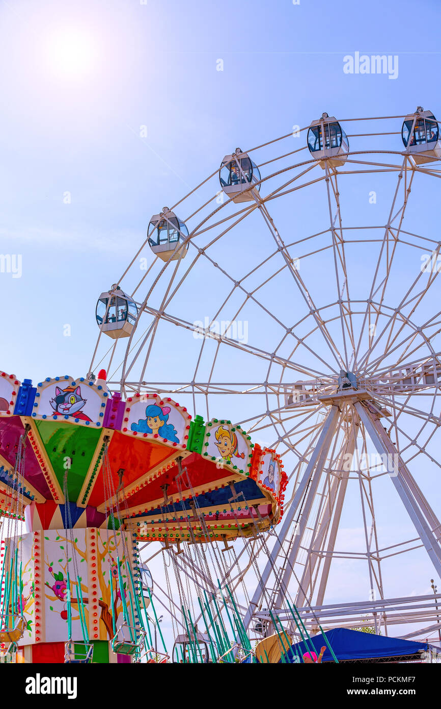 Amusement park rides with a very blue sky as background Stock Photo - Alamy