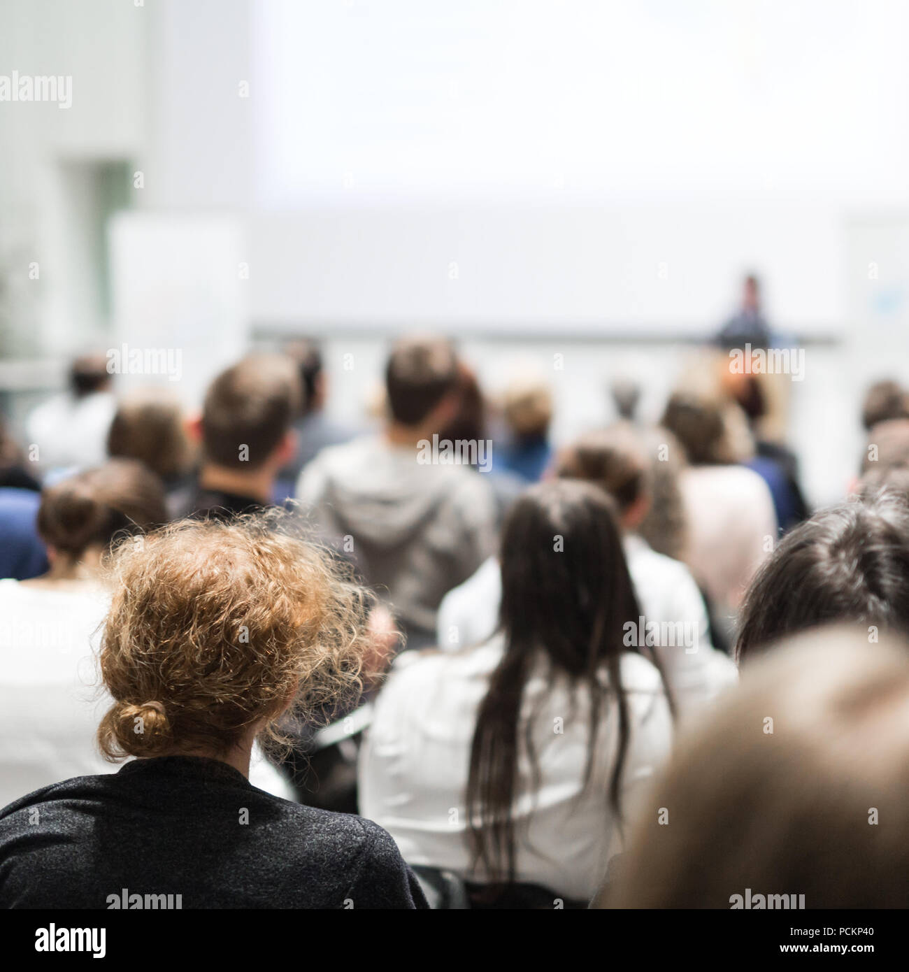 Woman giving presentation in lecture hall at university Stock Photo - Alamy