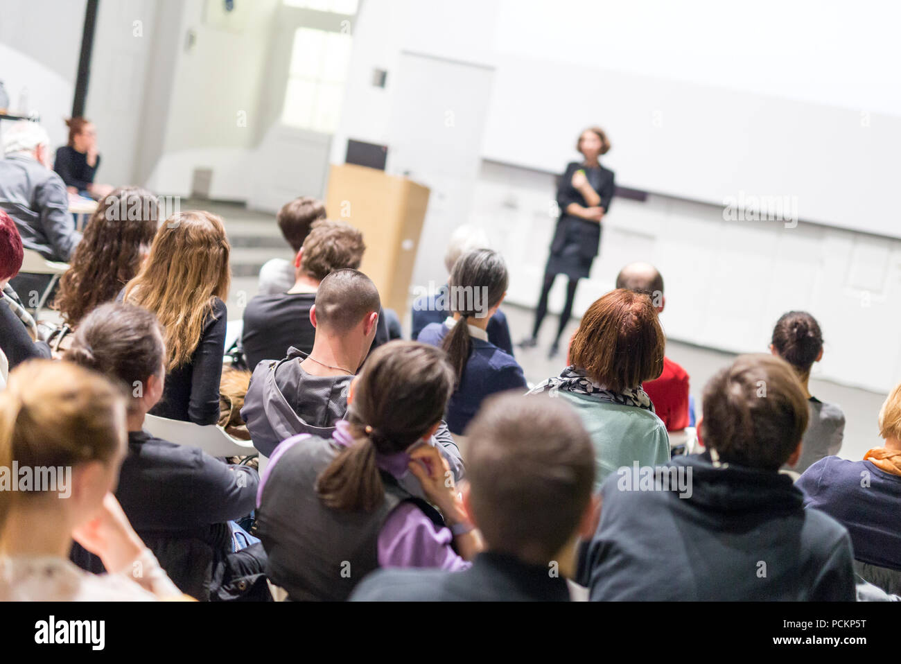 Woman giving presentation in lecture hall at university Stock Photo - Alamy