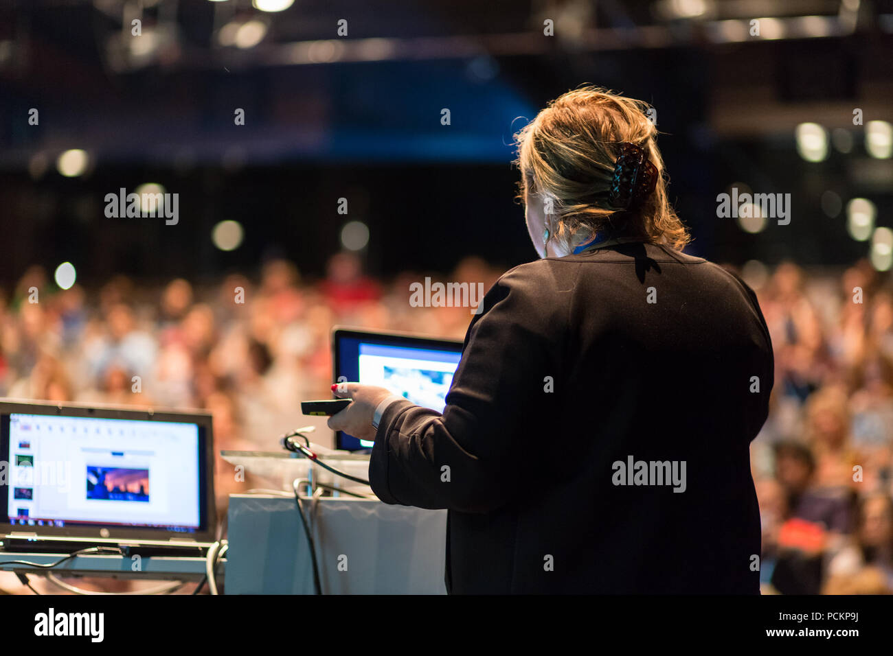 Female public speaker giving talk at Business Event Stock Photo - Alamy