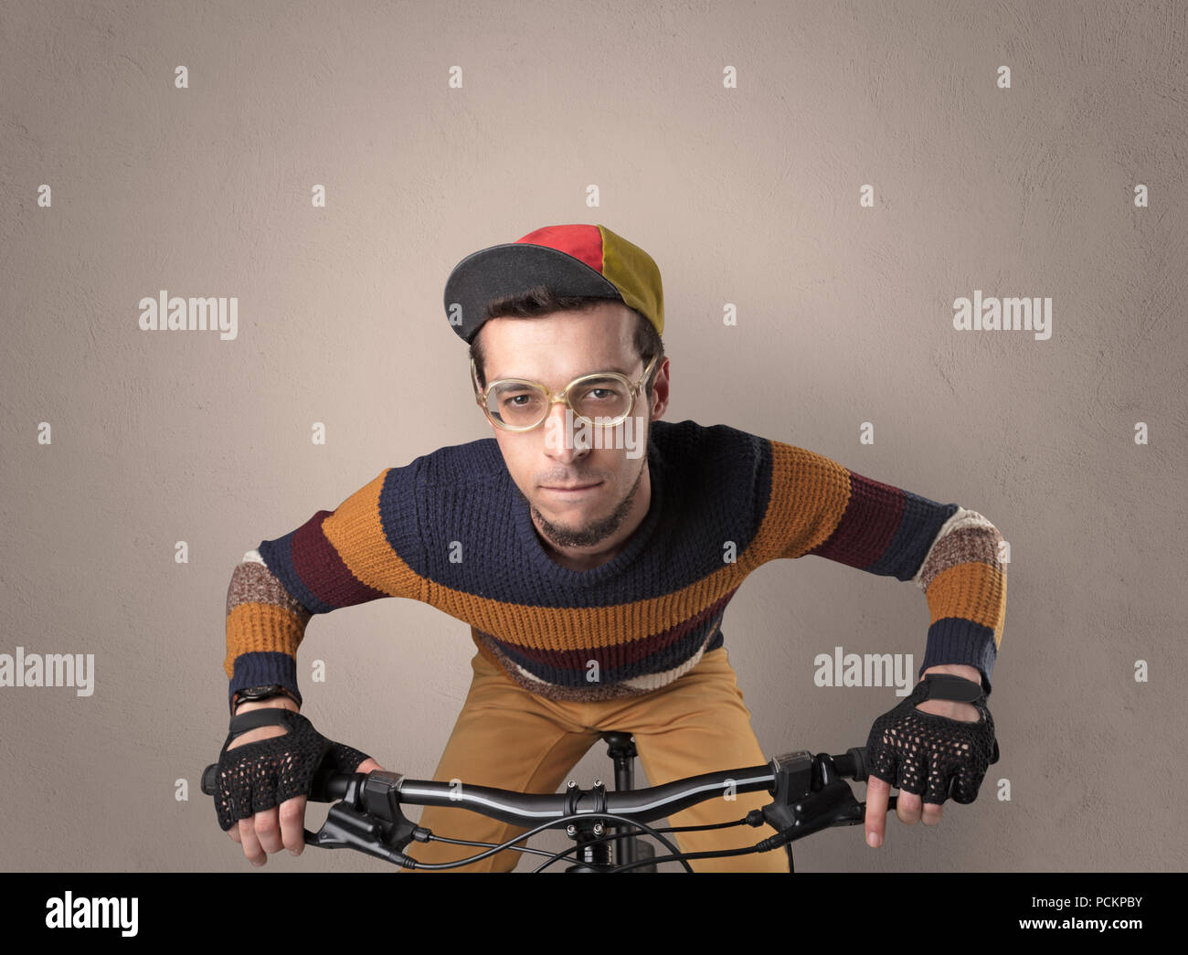 Nerd young foolish biker on a bike with oldschool outfit Stock Photo ...