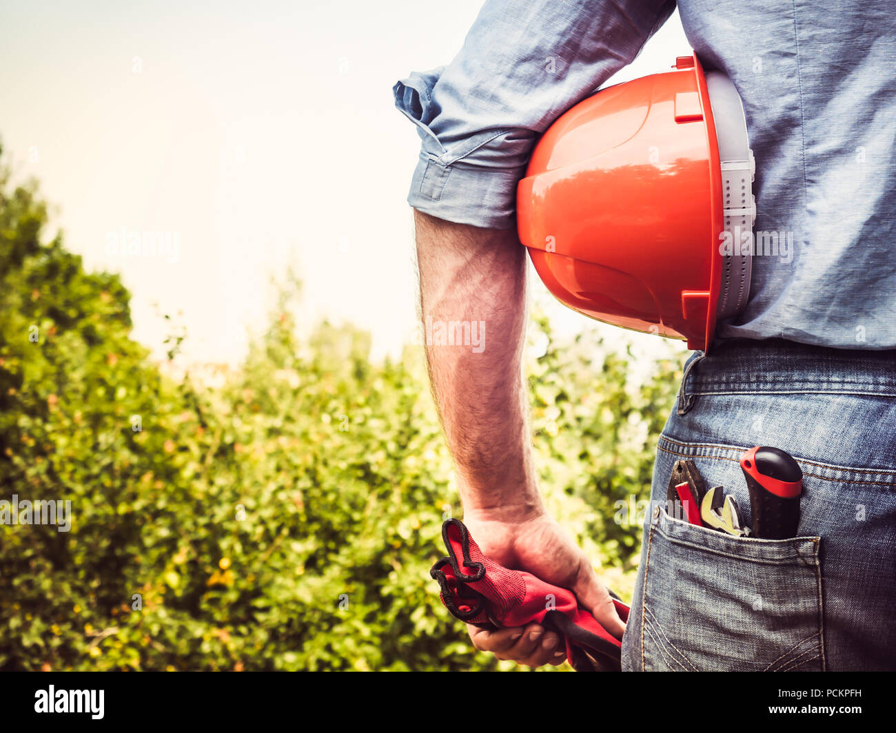 Man in work clothes with tools Stock Photo - Alamy
