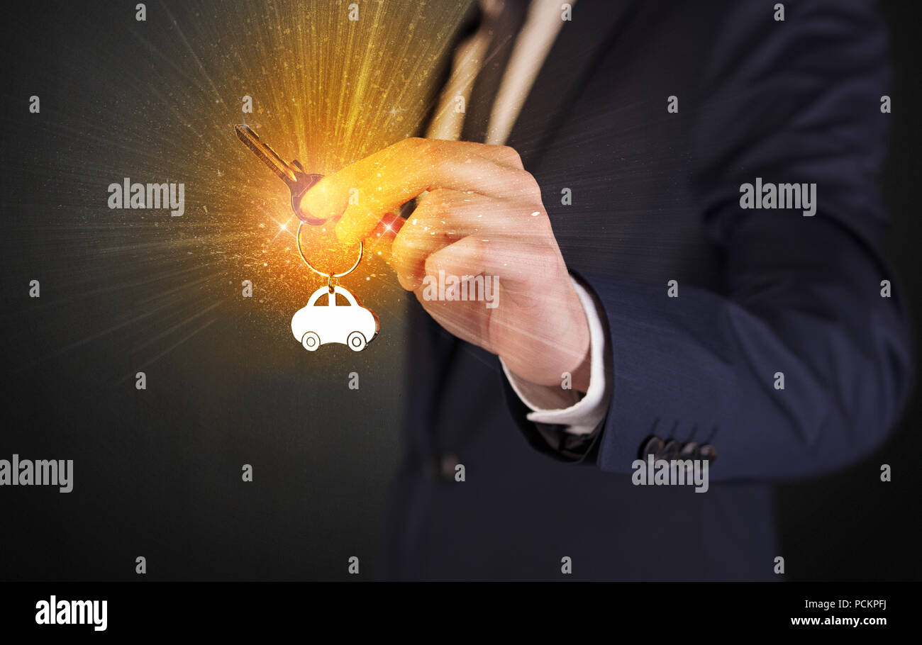 Formal man hand over shiny keys with dark background Stock Photo - Alamy