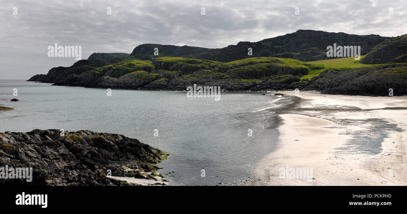 Panorama of sea cliffs and pasturland at Sandeels Bay above sandy beach ...