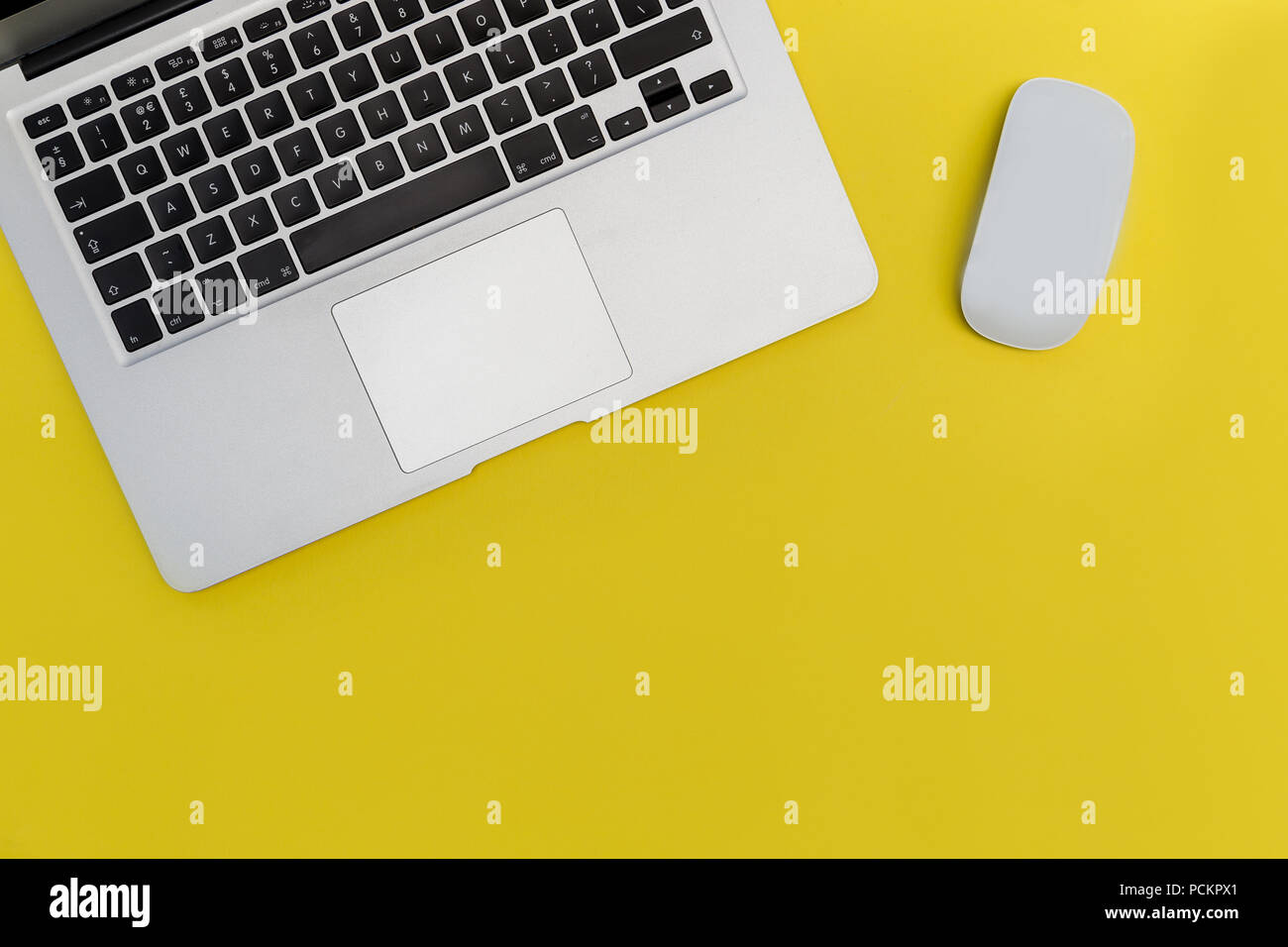 Laptop computer mouse on bright yellow background Stock Photo - Alamy