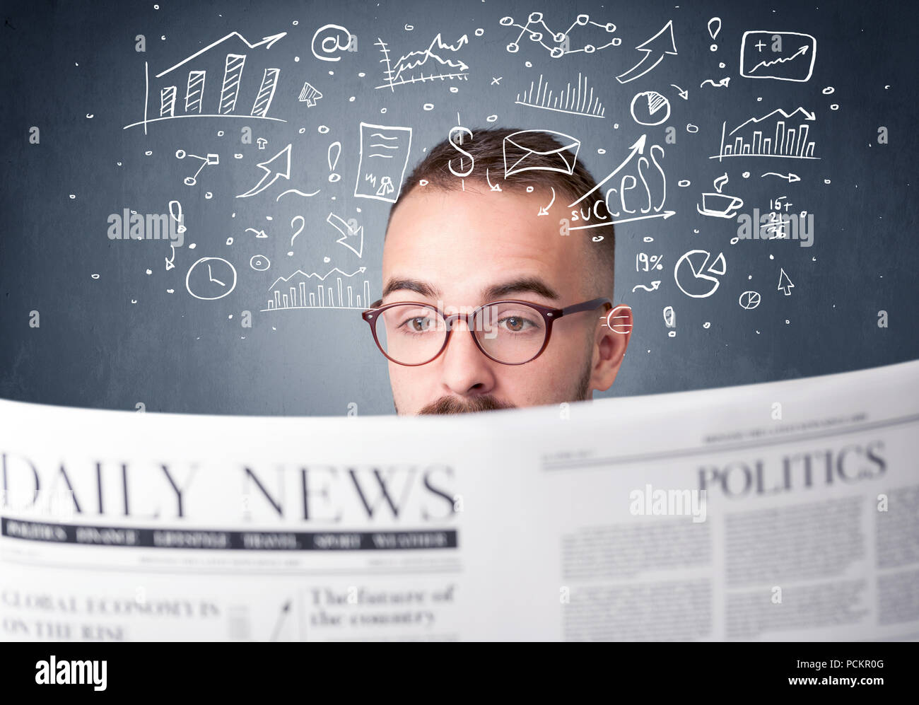 Young smart businessman reading daily newspaper with business plan ...