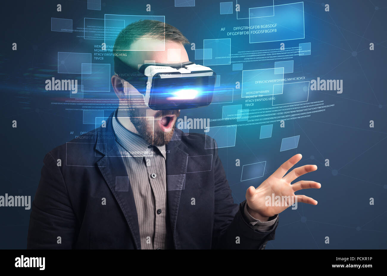 Amazed businessman with virtual reality data and blue squares in front ...