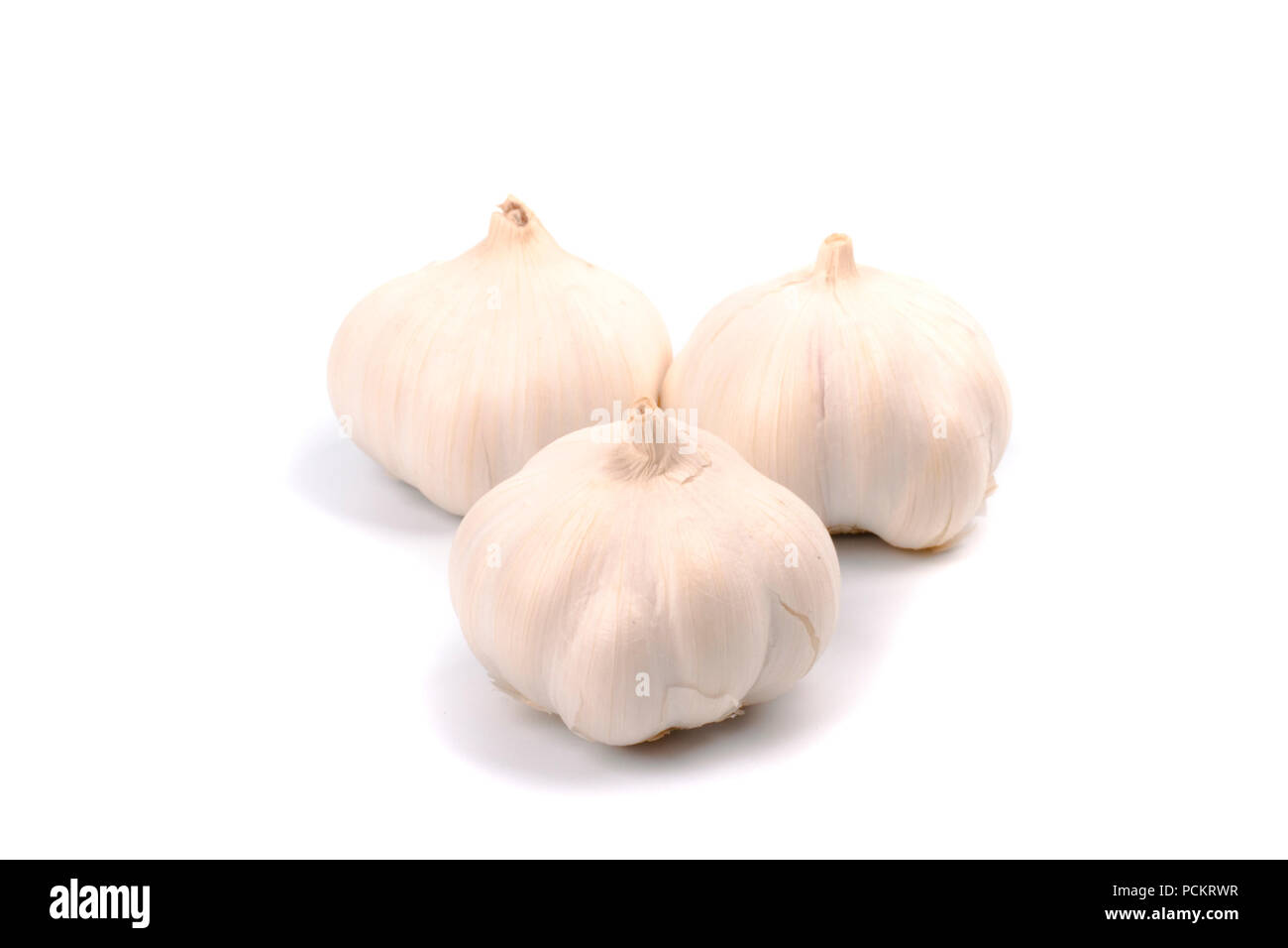 three garlics on white background Stock Photo - Alamy