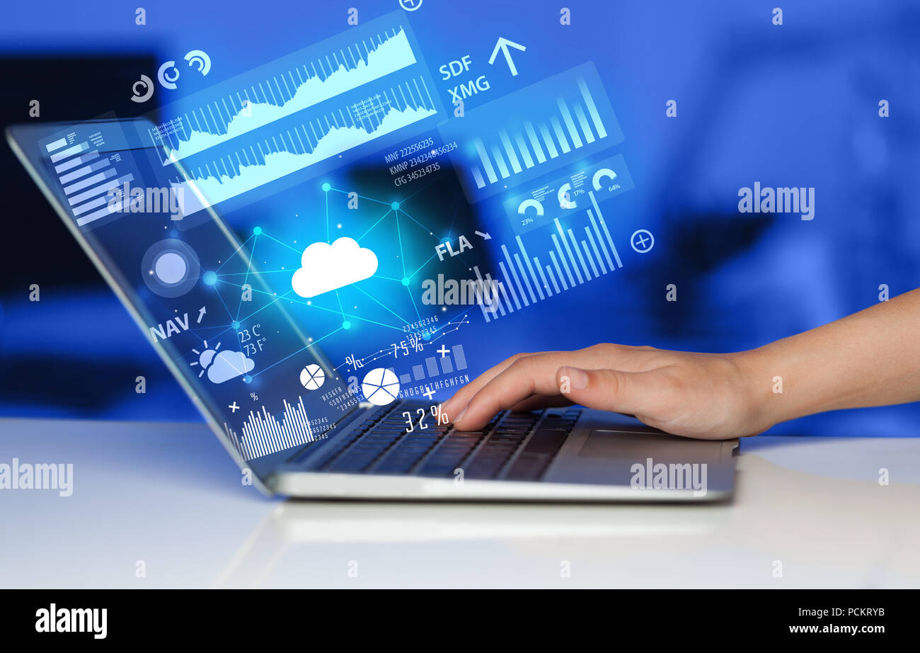 Hand using laptop with cloud technology and linked information concept ...