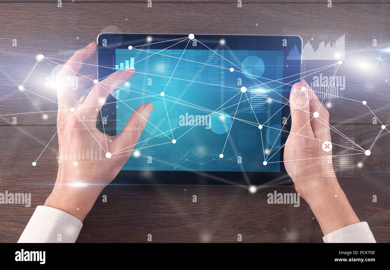 Hand using tablet with linking graphs charts report and informational ...