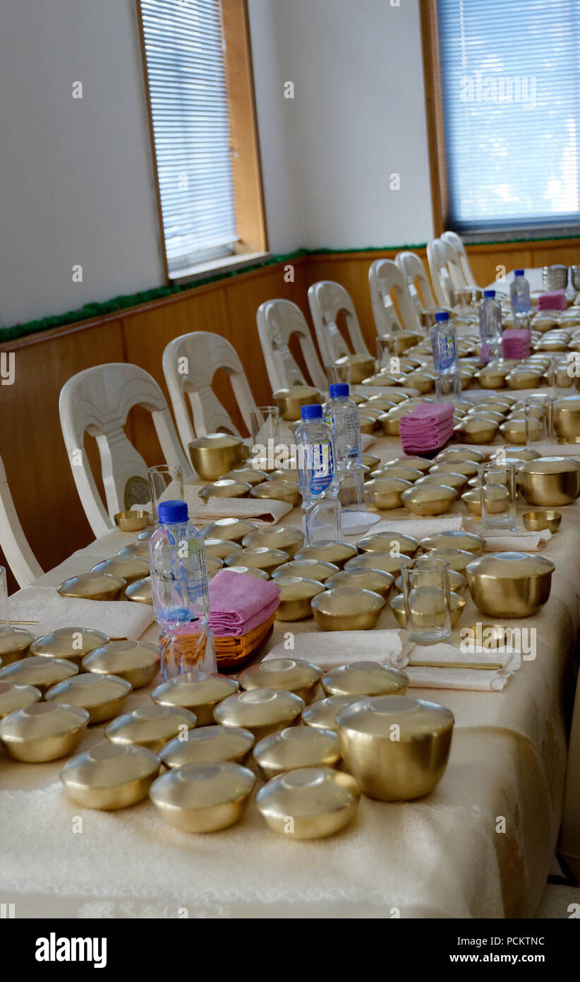 golden bowls and lids containing a sampling menu of North Korean food ...