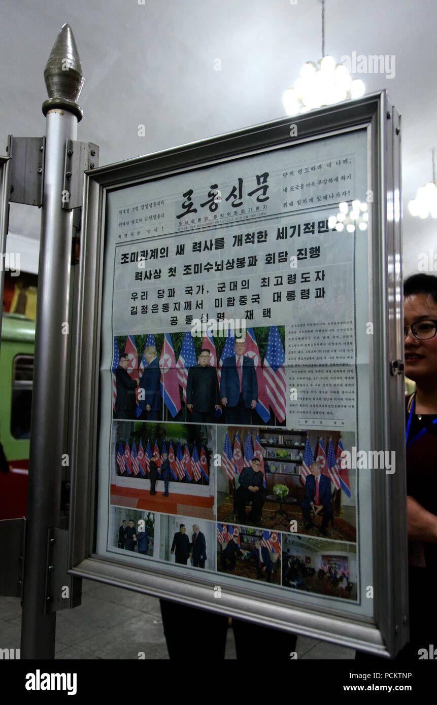 North Korean woman reading about the summit meeting of Kim Jong-un and ...