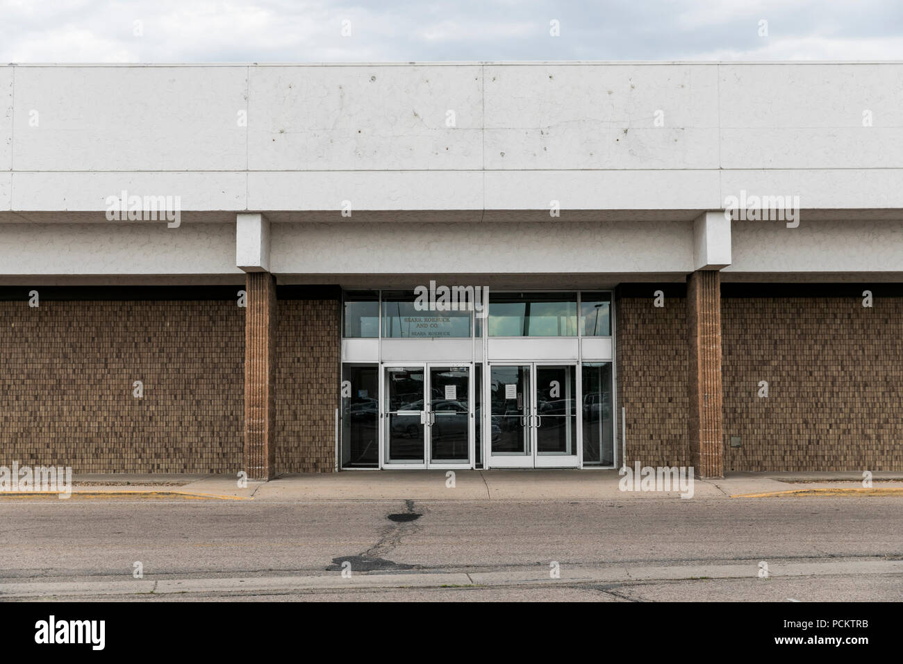 The outline of a logo sign at a closed Sears retail store location in ...