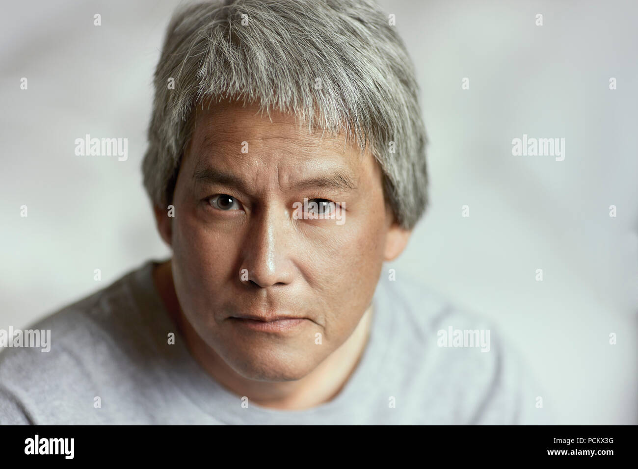 Portrait of a Chinese man with gray hair, brown eyes and shallow depth ...