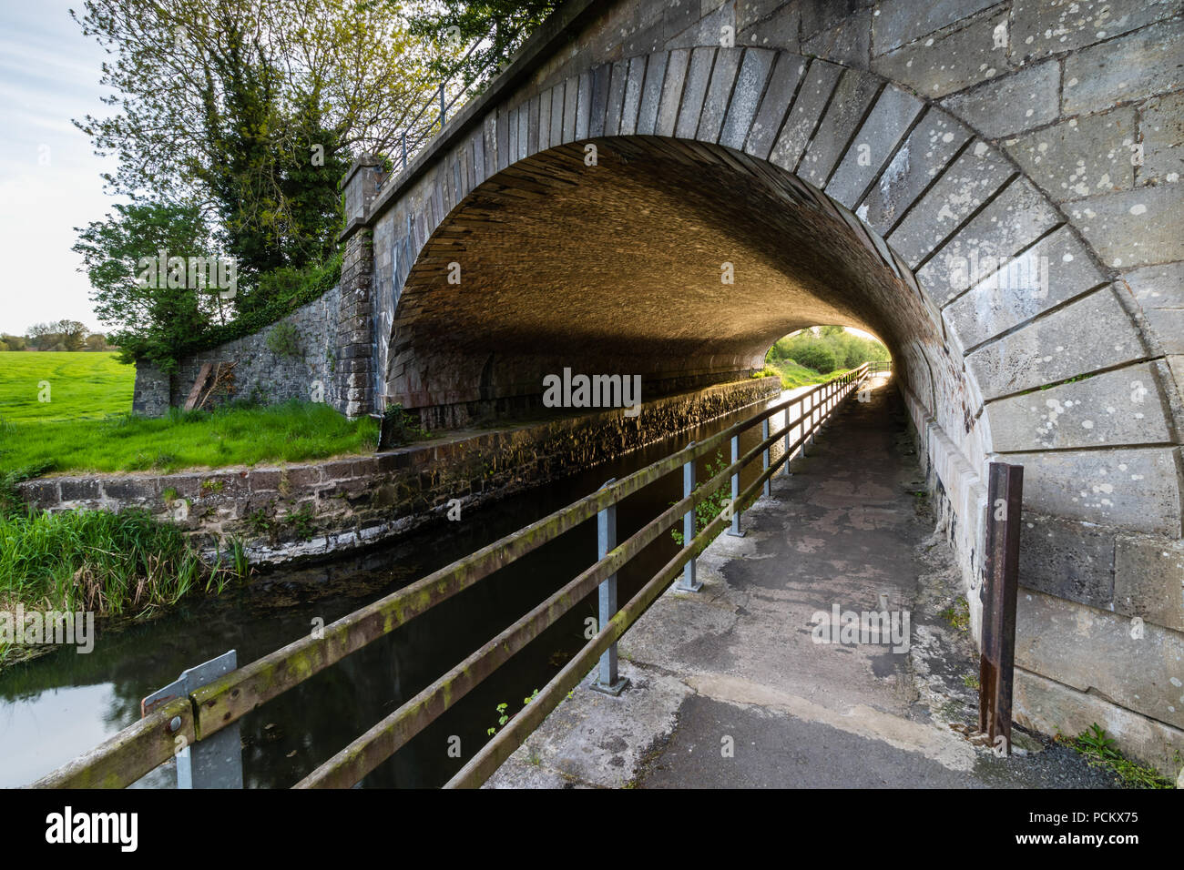 Late evening light shining under the roof of a stone bridge in Moira ...