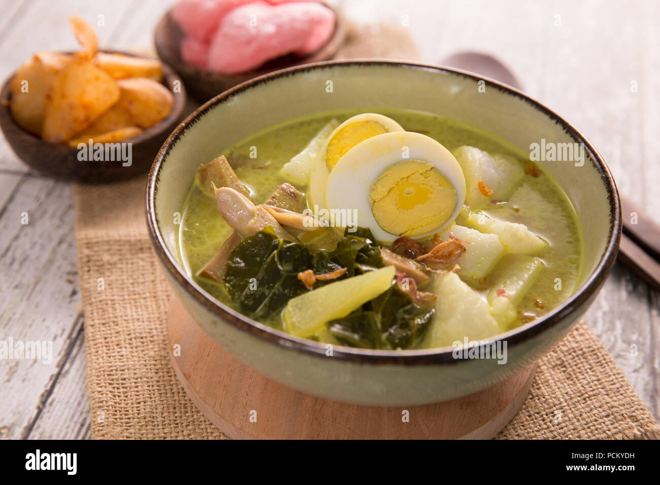 lontong sayur. rice cake with soup and vegetable. indonesian ...