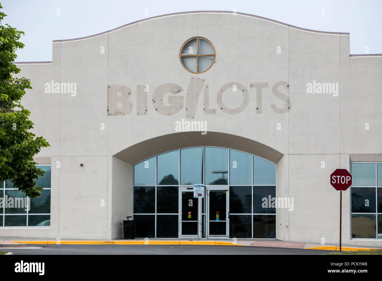 The faded outline of a logo sign outside of a closed Big Lots retail ...