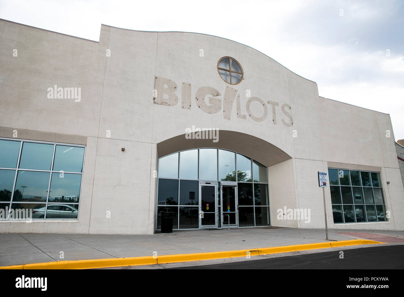 The faded outline of a logo sign outside of a closed Big Lots retail ...