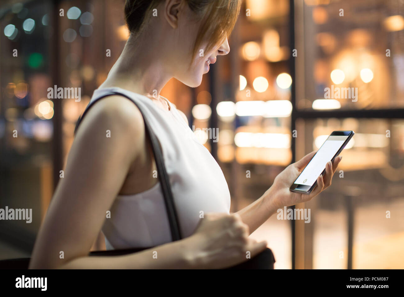 Cheerful young Chinese woman using smart phone Stock Photo - Alamy