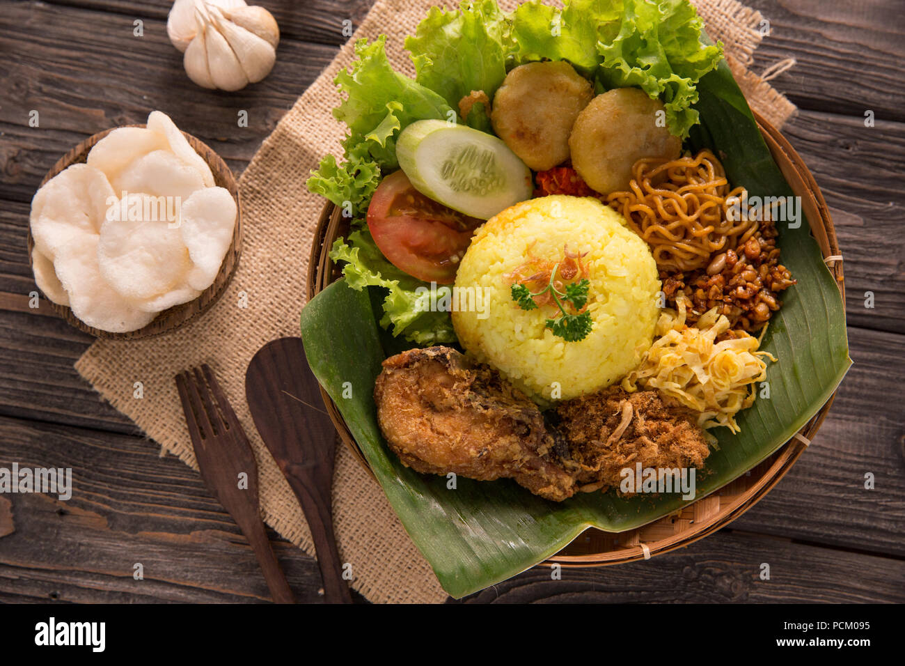 indonesian traditional yellow rice served with banana leaf plate Stock ...