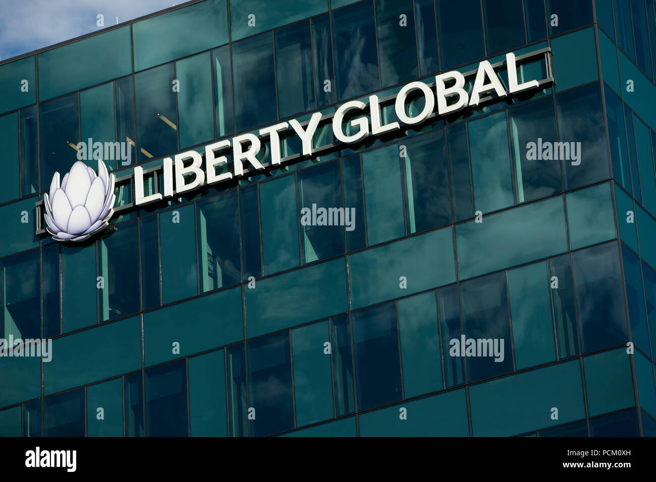 A logo sign outside of a facility occupied by Liberty Global in Denver ...