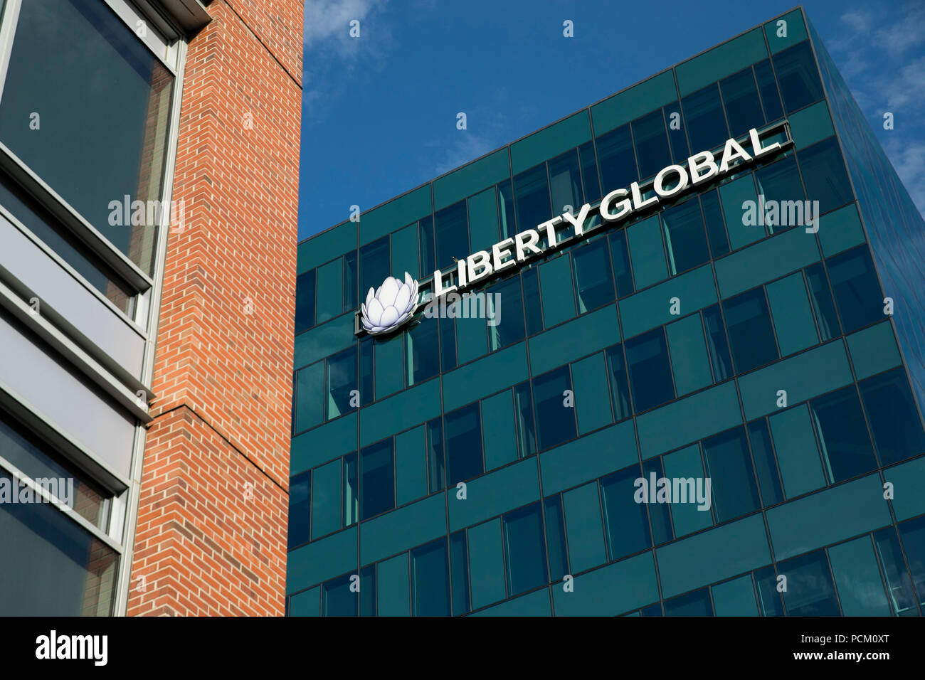 A logo sign outside of a facility occupied by Liberty Global in Denver ...