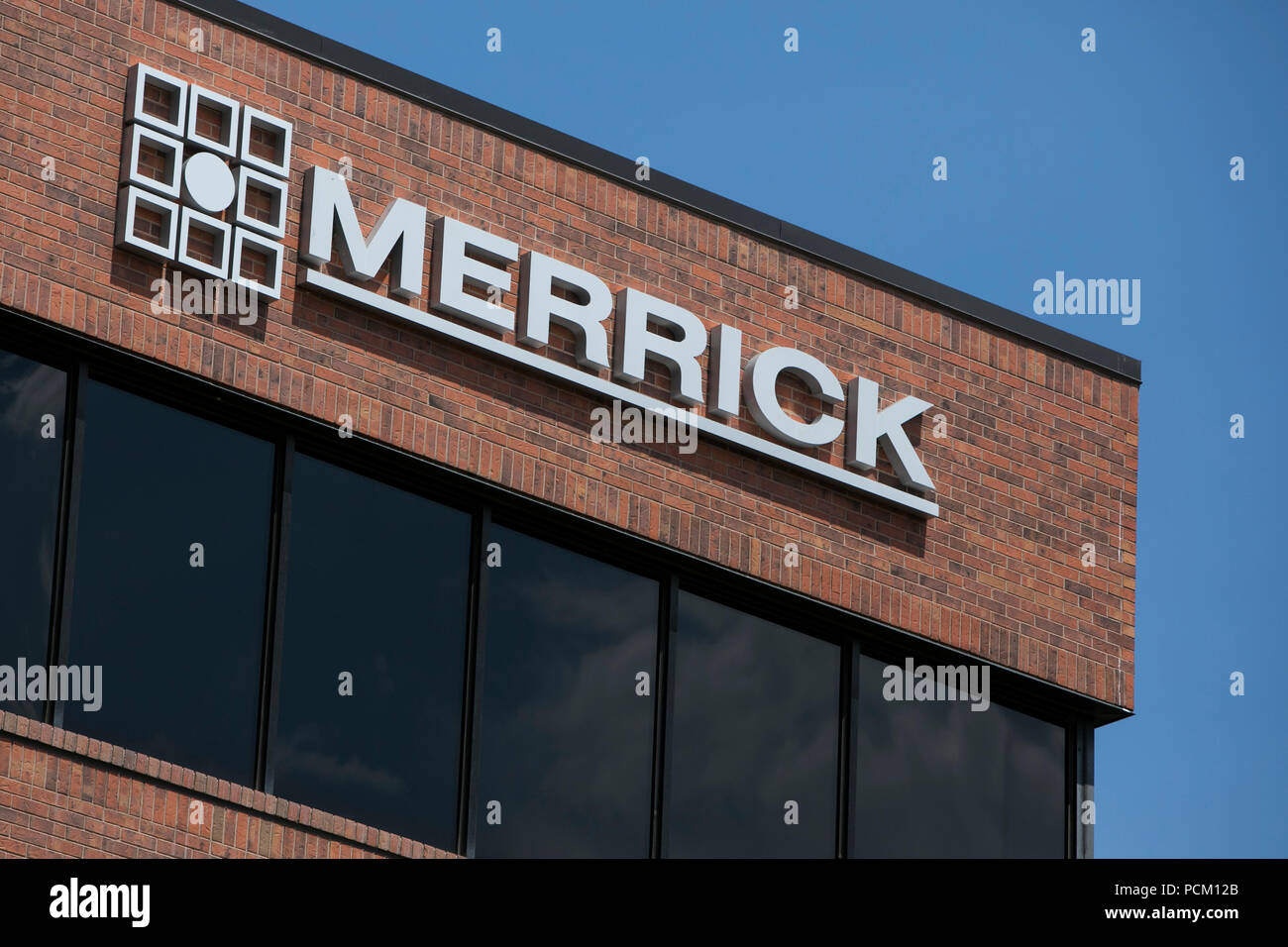 A logo sign outside of a facility occupied by Merrick & Company in ...