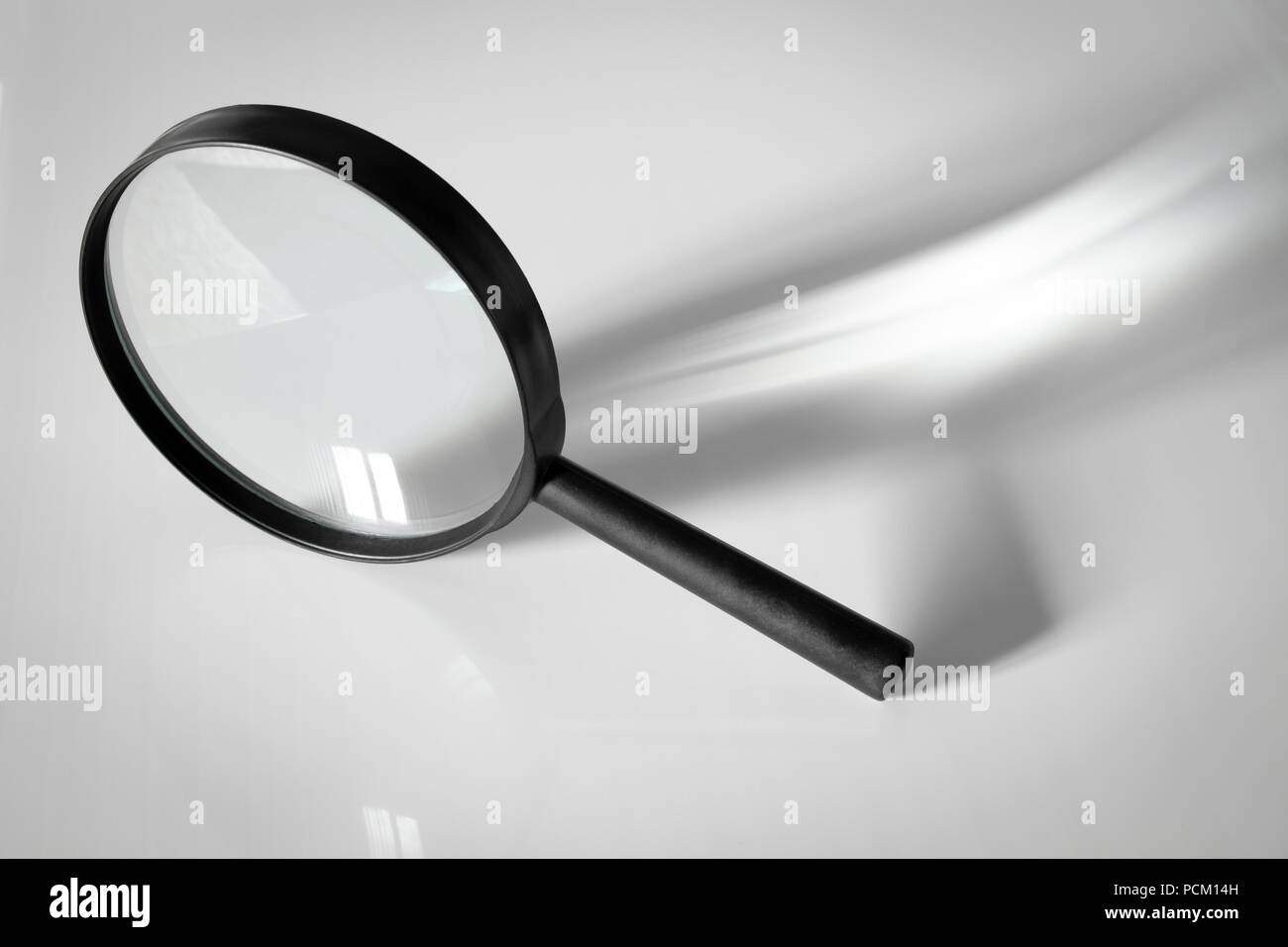 Magnifier with handle close-up on a white background Stock Photo - Alamy