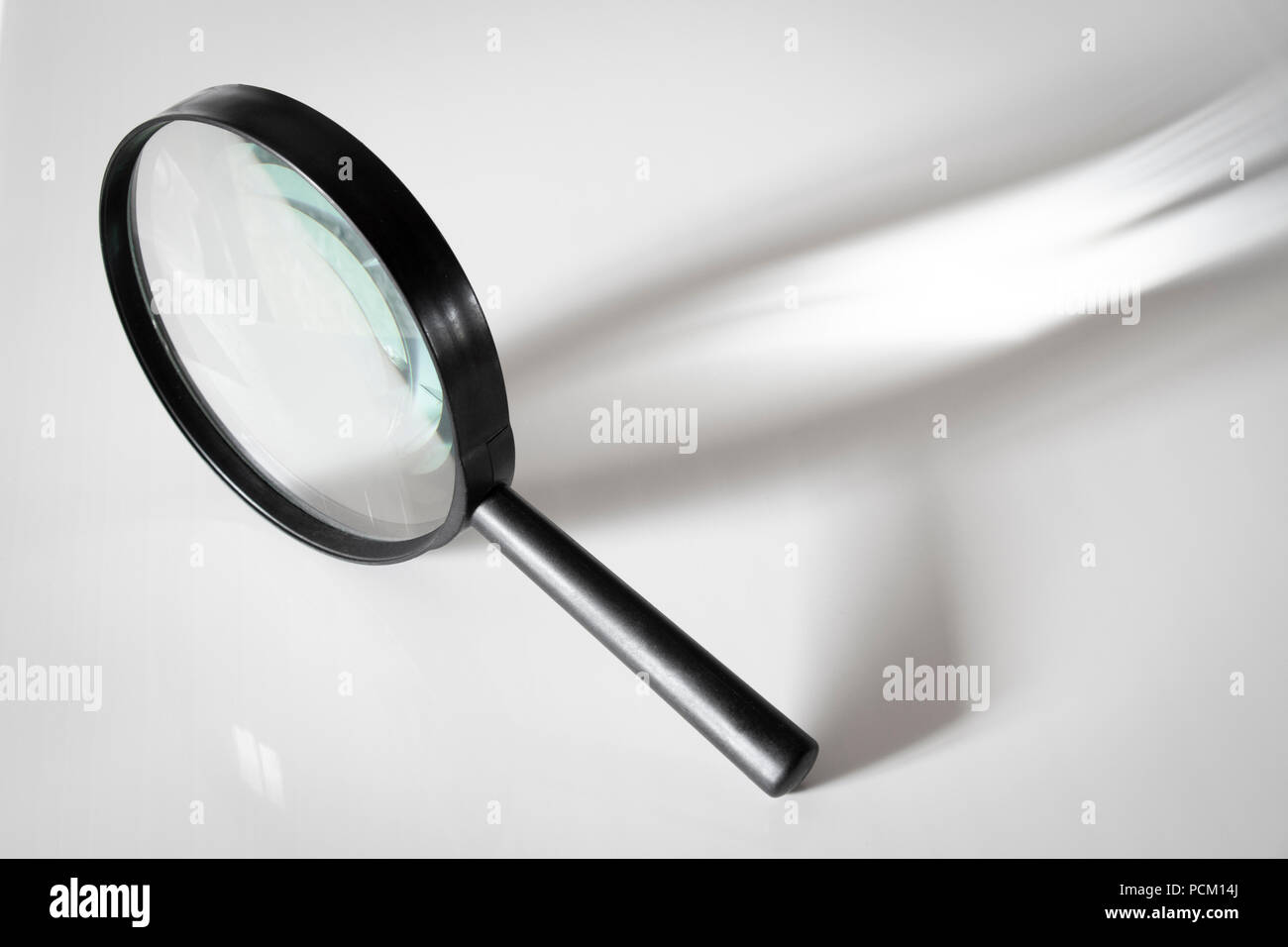 A shadow from a magnifying glass on a white background Stock Photo - Alamy