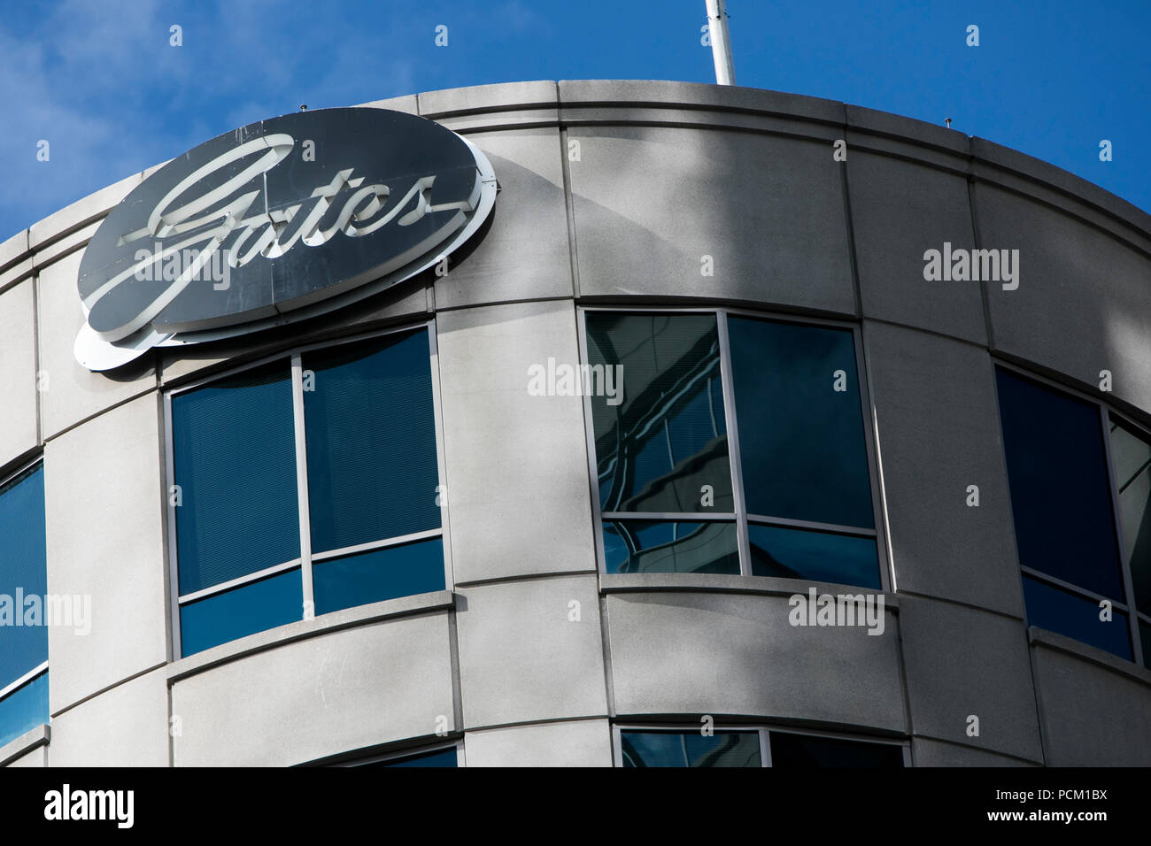 A logo sign outside of the headquarters of the Gates Corporation in ...