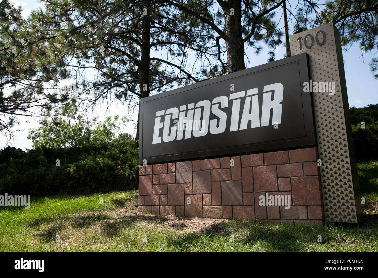 A logo sign outside of the headquarters of the EchoStar Corporation in ...