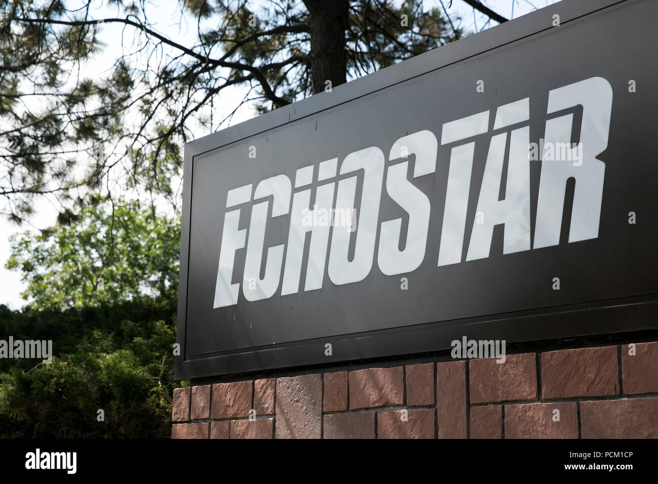 A logo sign outside of the headquarters of the EchoStar Corporation in ...