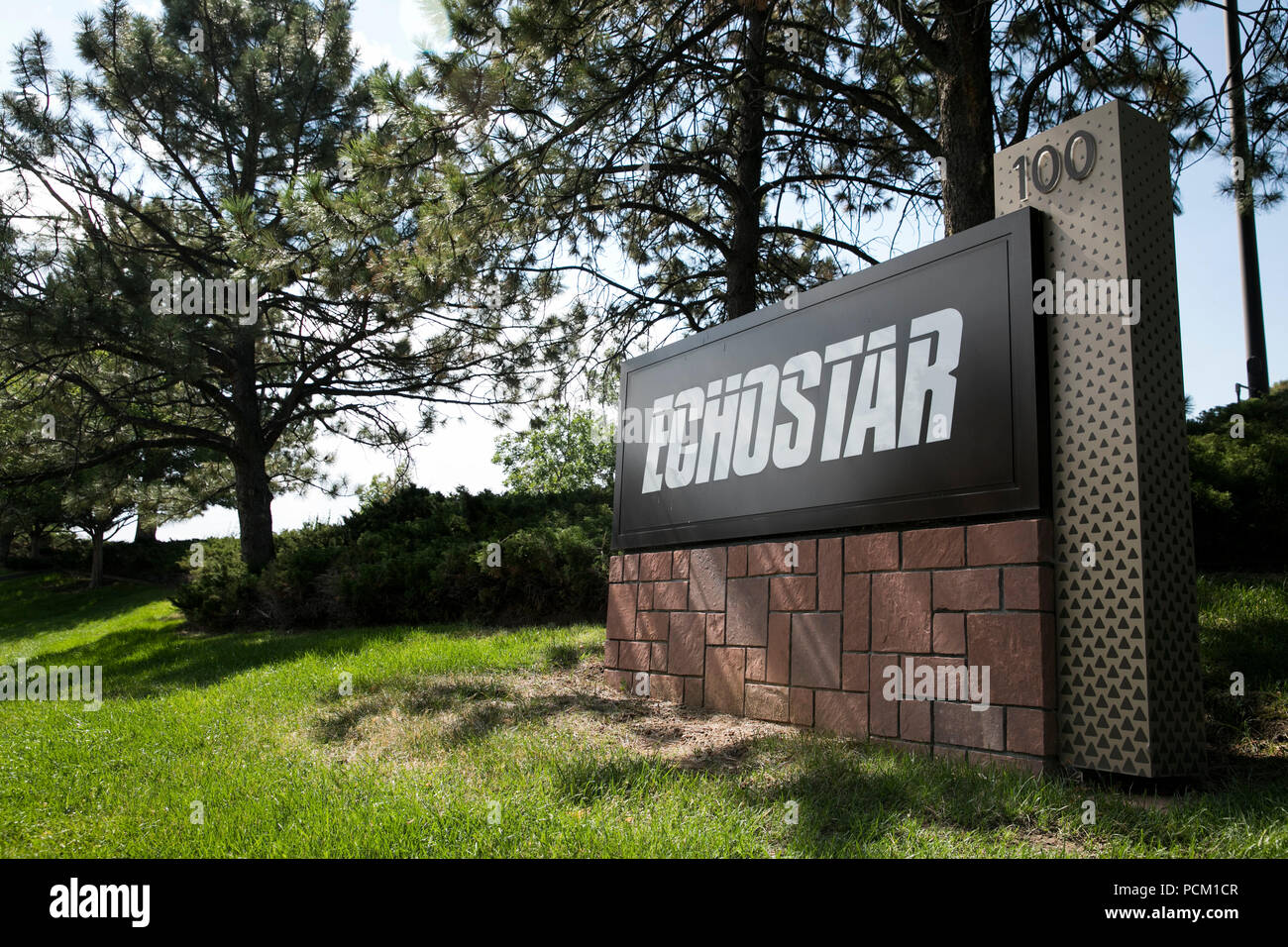 A logo sign outside of the headquarters of the EchoStar Corporation in ...