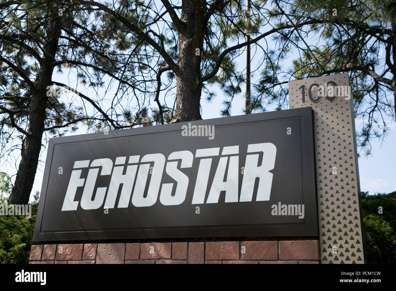 A logo sign outside of the headquarters of the EchoStar Corporation in ...