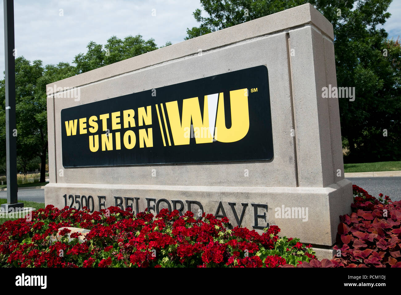 A logo sign outside of the headquarters of The Western Union Company in ...