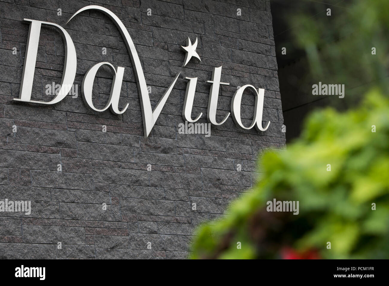 A logo sign outside of the headquarters of DaVita, Inc., in Denver ...