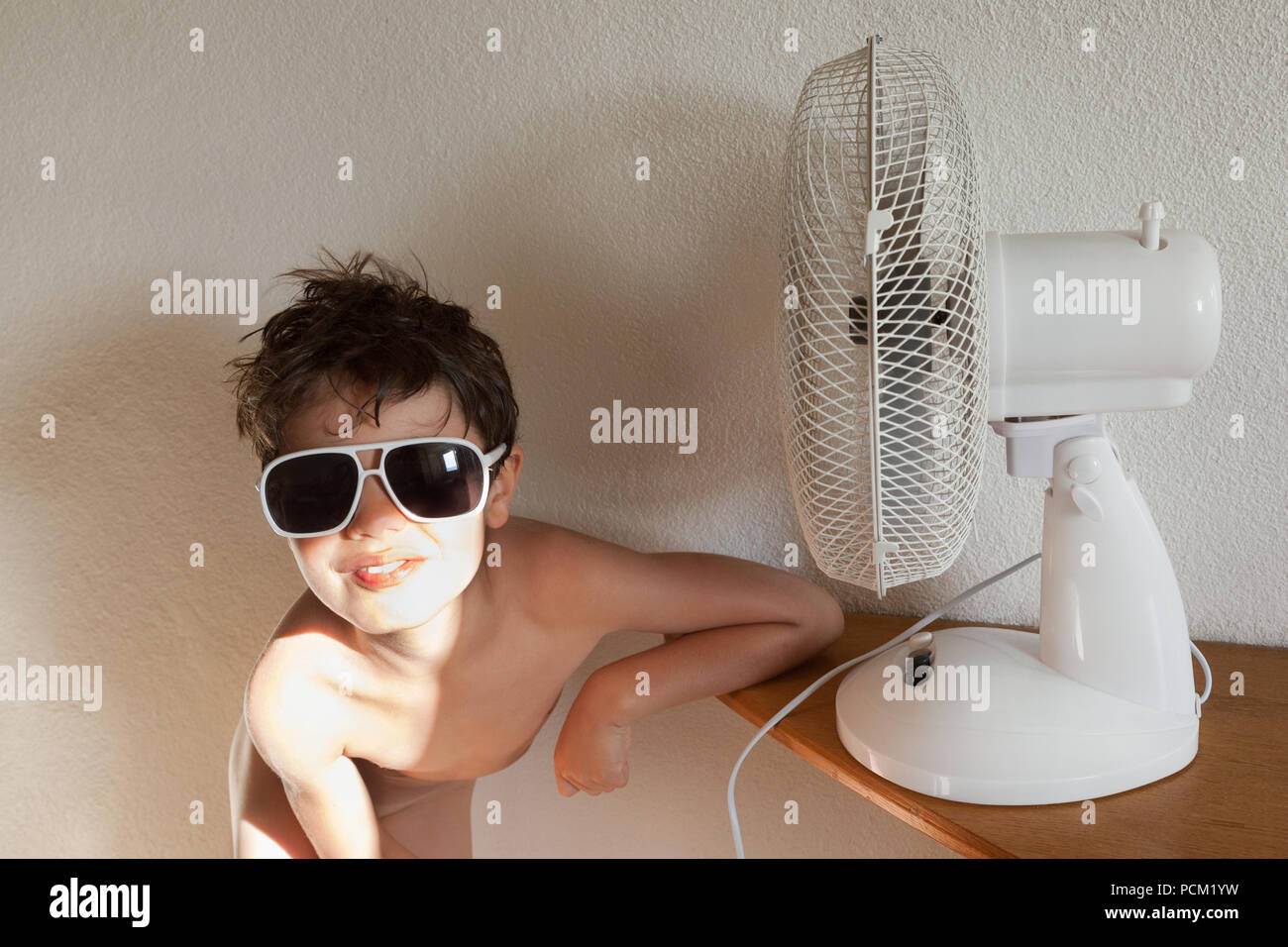 boy cools with a fan, portrait Stock Photo - Alamy