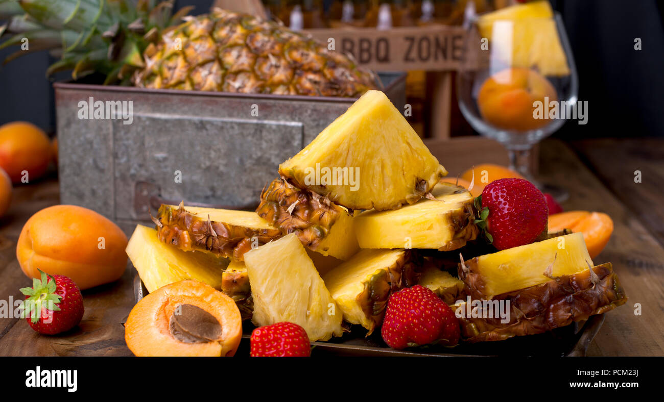 ripe tropical fruits for juice and cocktail at a party. A box of beer ...
