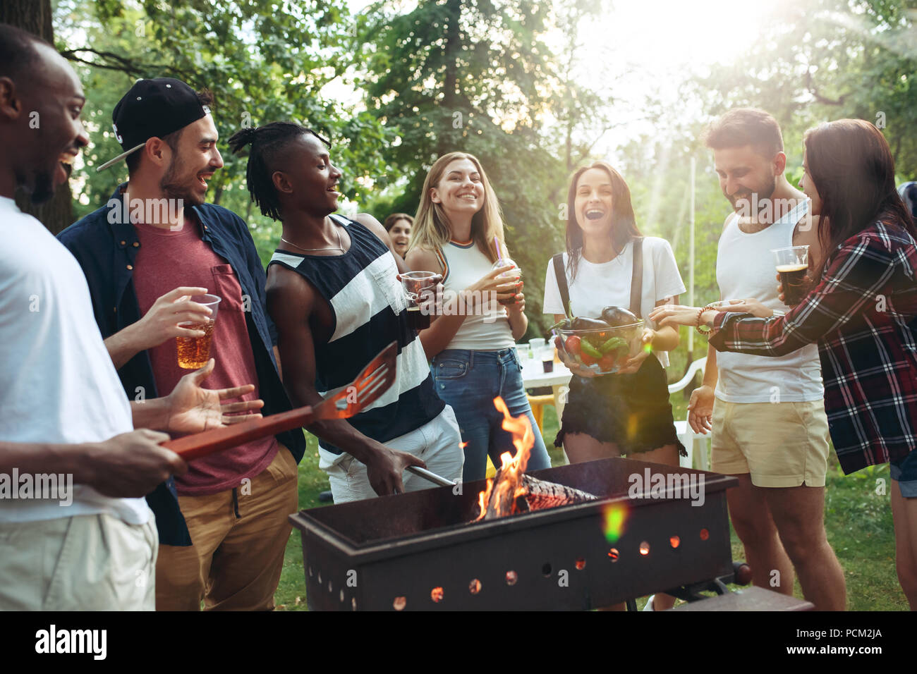 Group of friends making barbecue in the backyard. concept about good ...